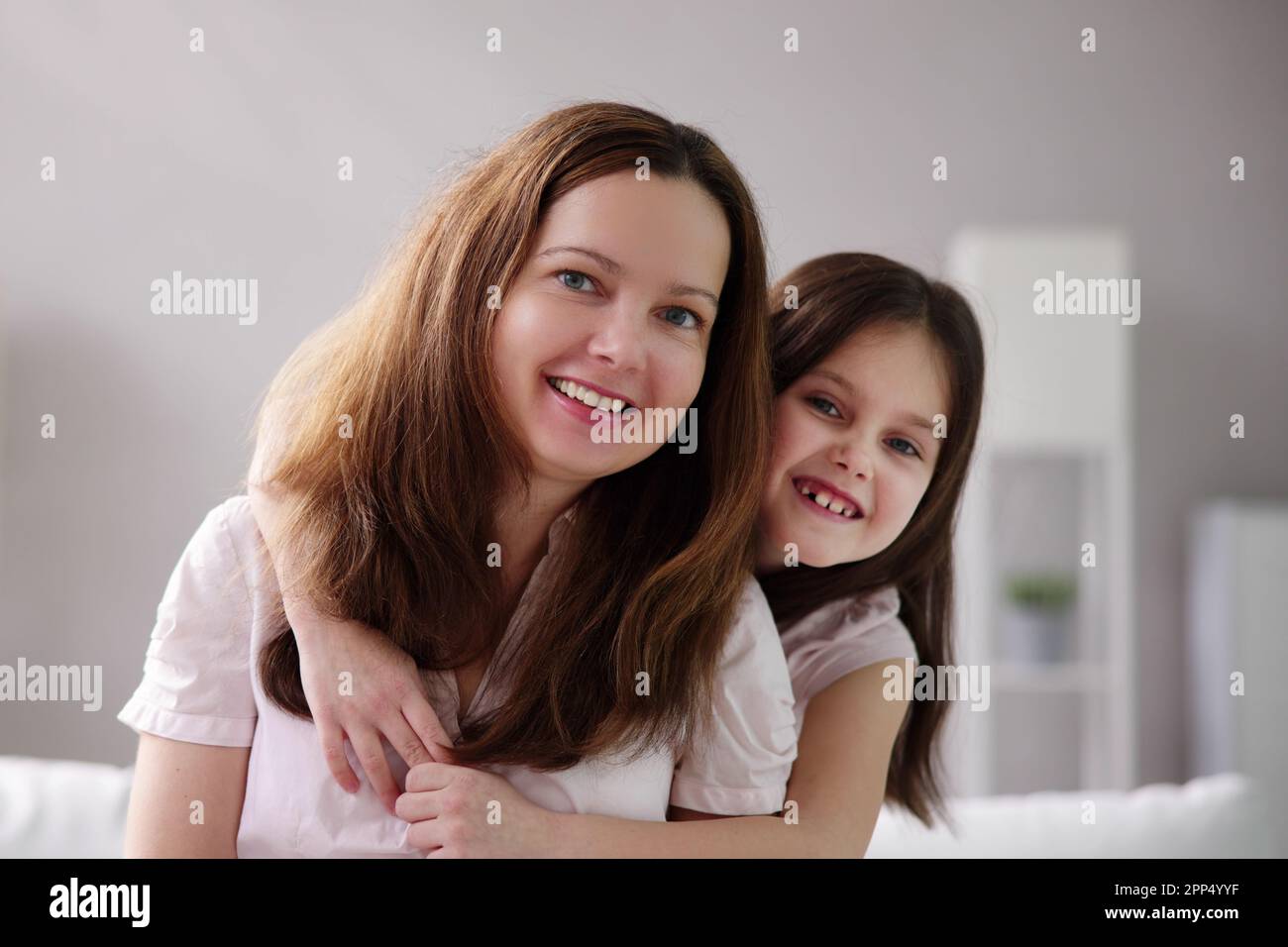 Happy Mom Embracing Smiling Child. Kid Hug Stock Photo - Alamy