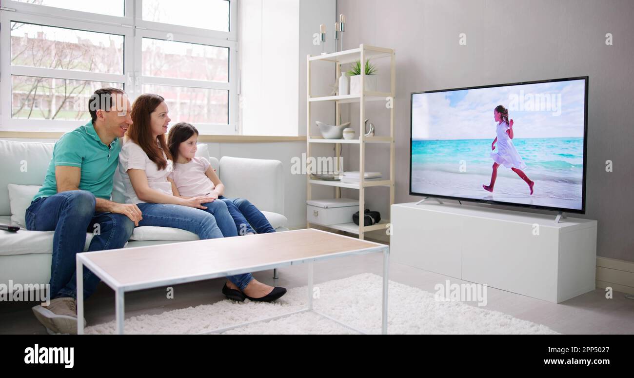 Young Family Watching TV Together At Home Stock Photo - Alamy