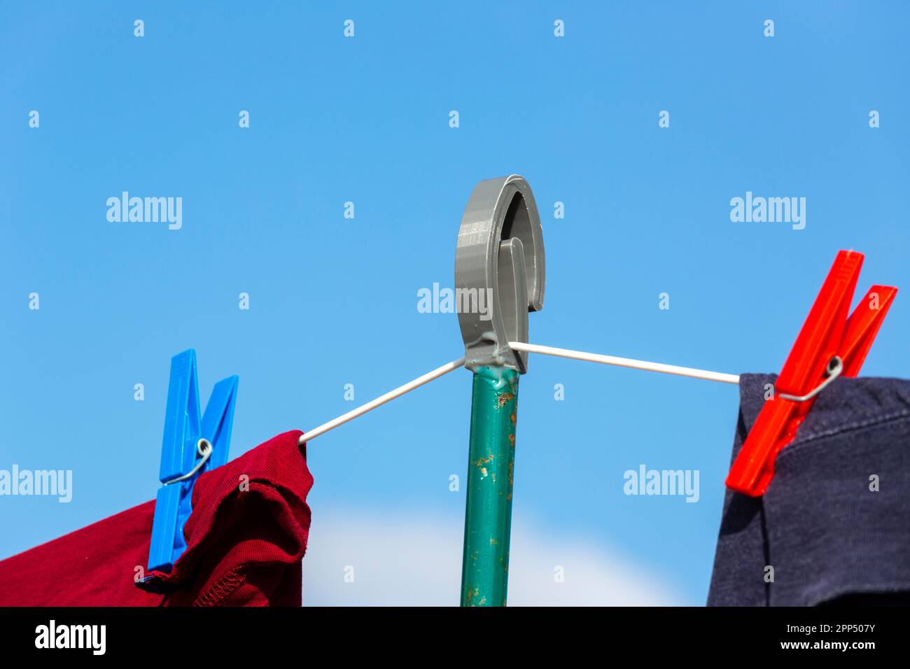 Clothes drying on a washing line with blue sky Stock Photo - Alamy