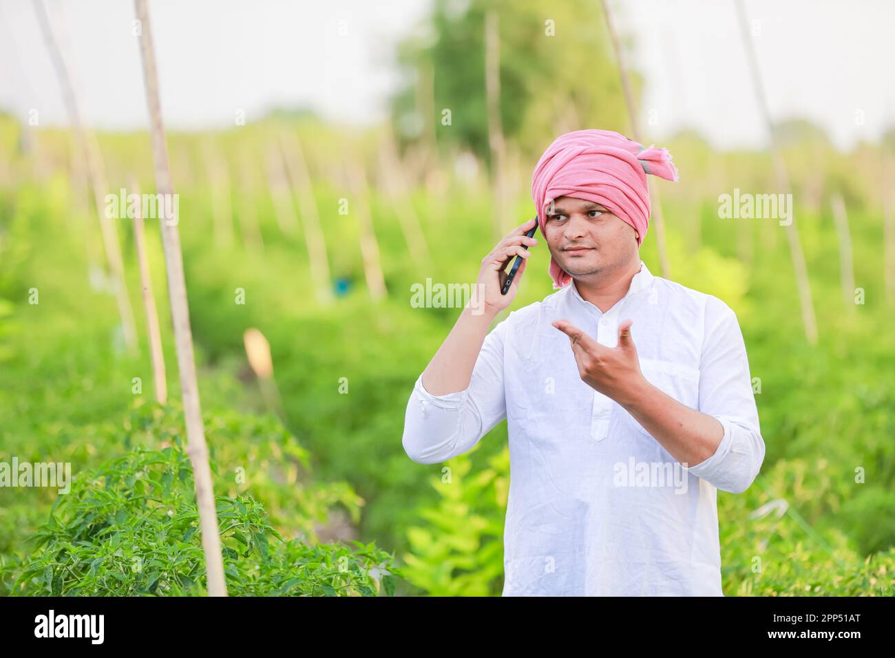 Young indian farmer showing Smart phone , Farmer talking on phone in ...