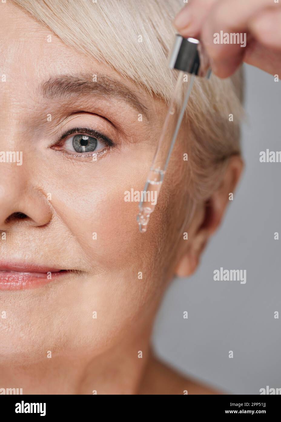 Close up woman using face serum Stock Photo - Alamy