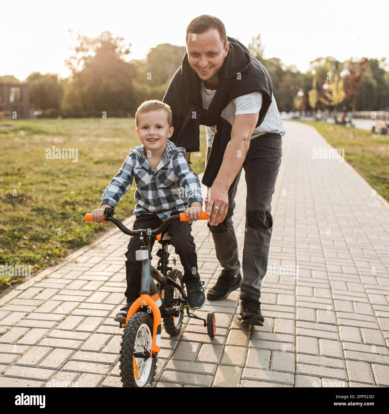 Father helping his son riding bicycle Stock Photo - Alamy Father helping his son riding bicycle Stock Photo - Alamy
