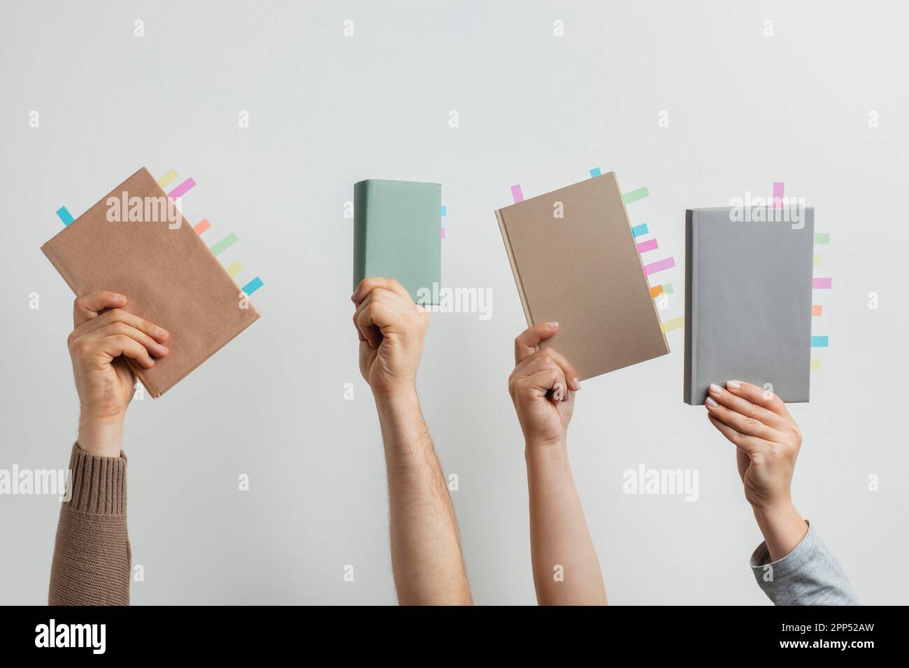 People holding books with colorful reminders stickers Stock Photo - Alamy