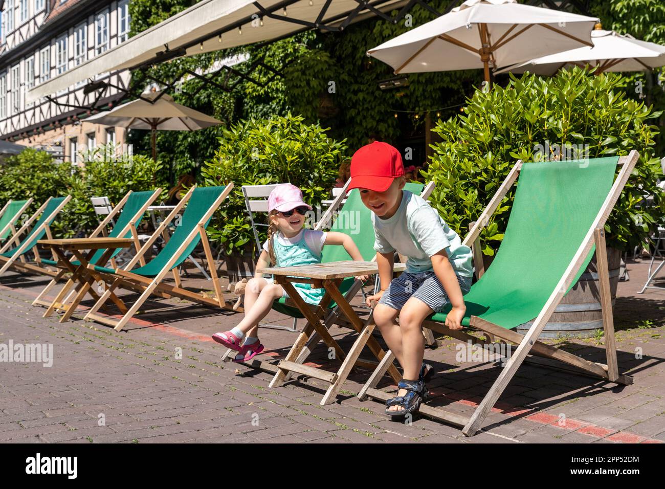 Pair of cute adorable little children enjoy having fun chilling on ...