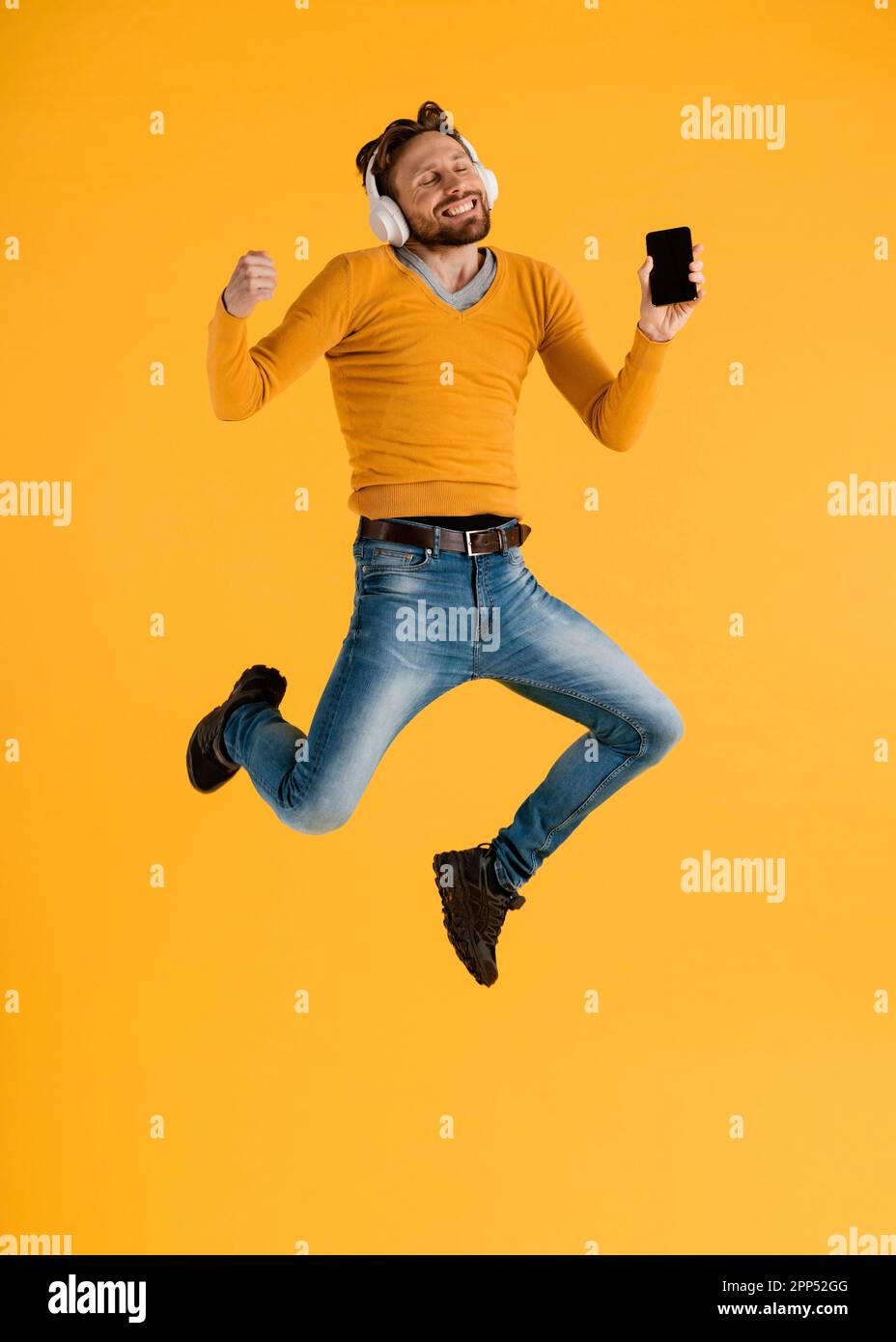 Young man jumping mobile phone hi-res stock photography and images - Alamy