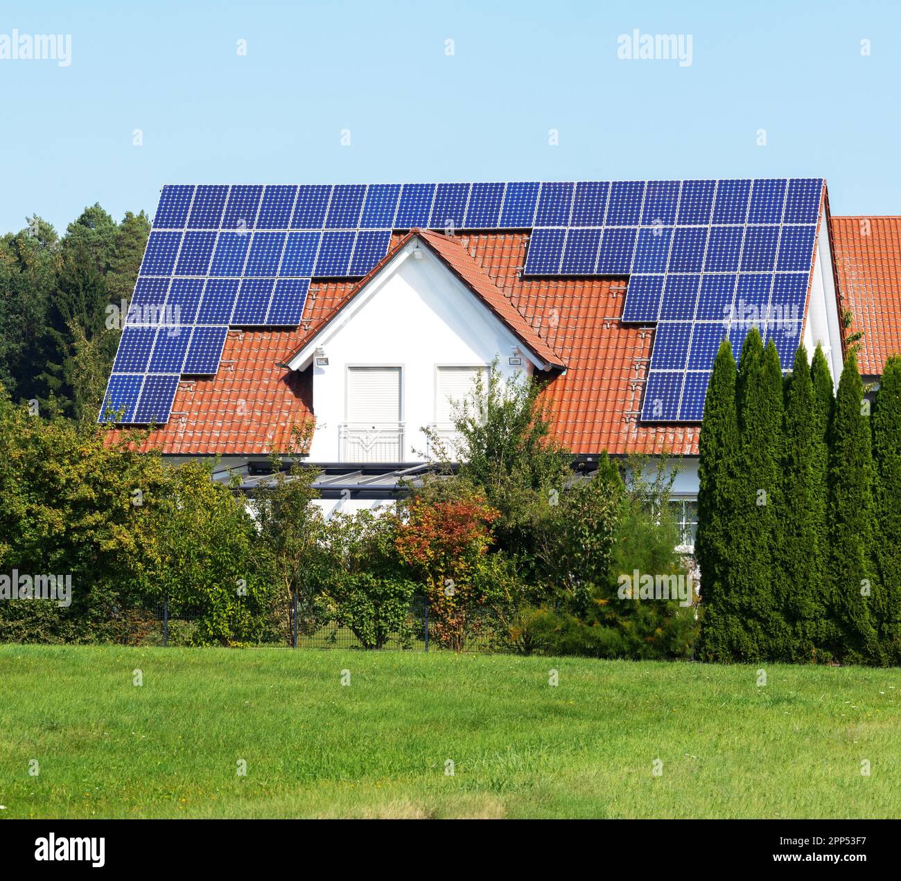 Modern house with photovoltaic solar cells on the roof for alternative ...