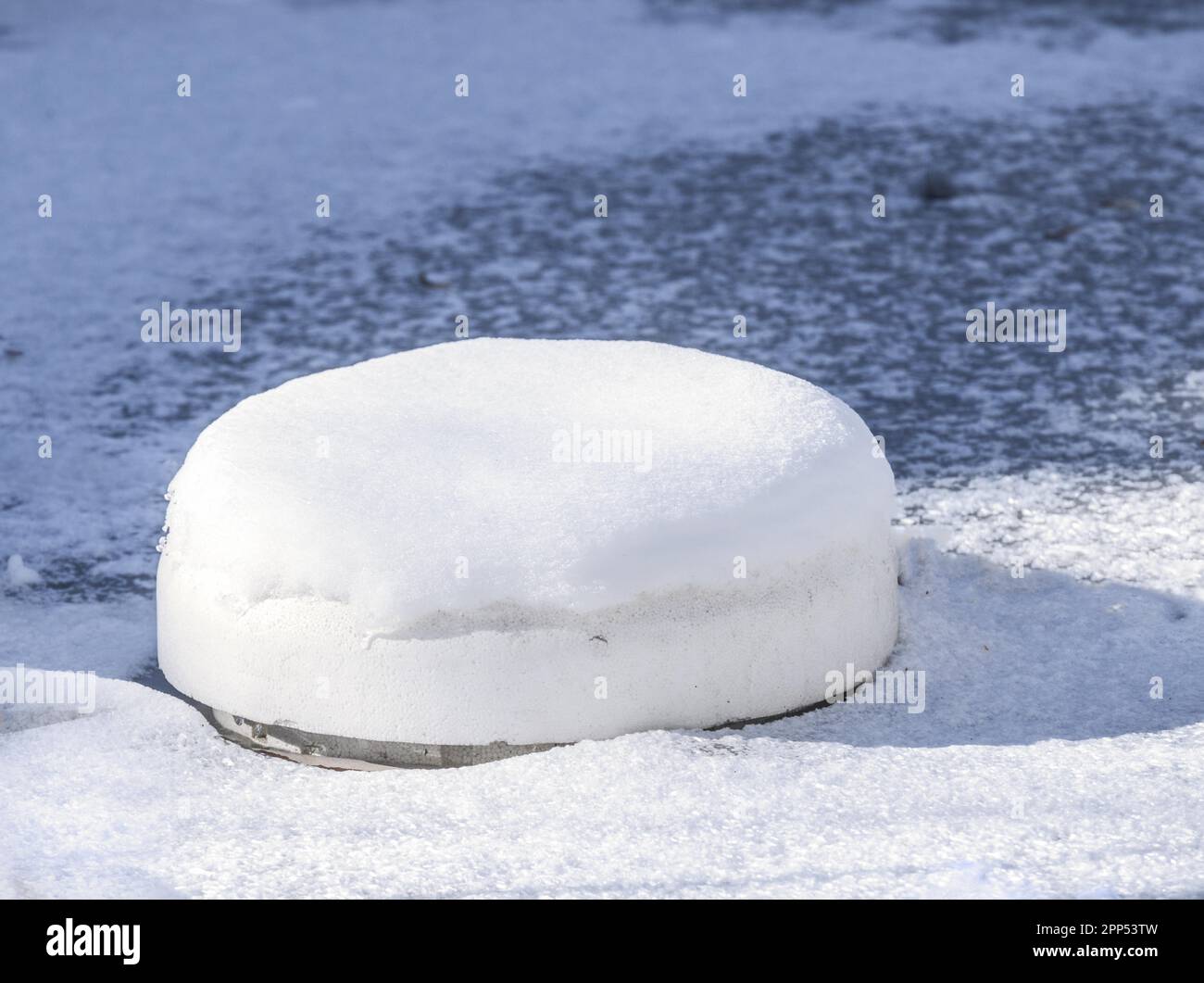 Floating ice preventer made of styrofoam in a frozen pond Stock Photo ...