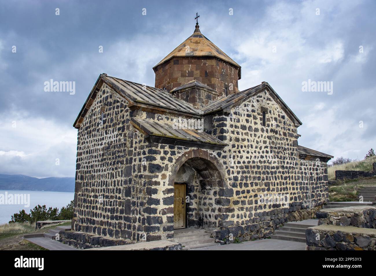 Monastery under dramatic spring sky photo. Ancient church near lake ...