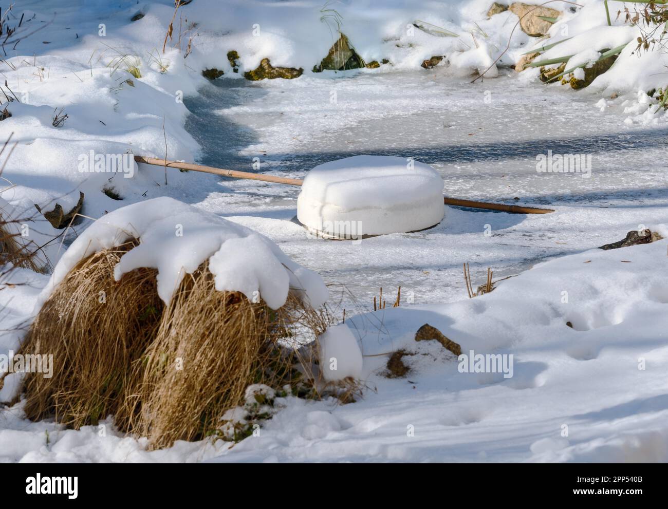 Floating ice preventer made of styrofoam in a frozen pond Stock Photo ...