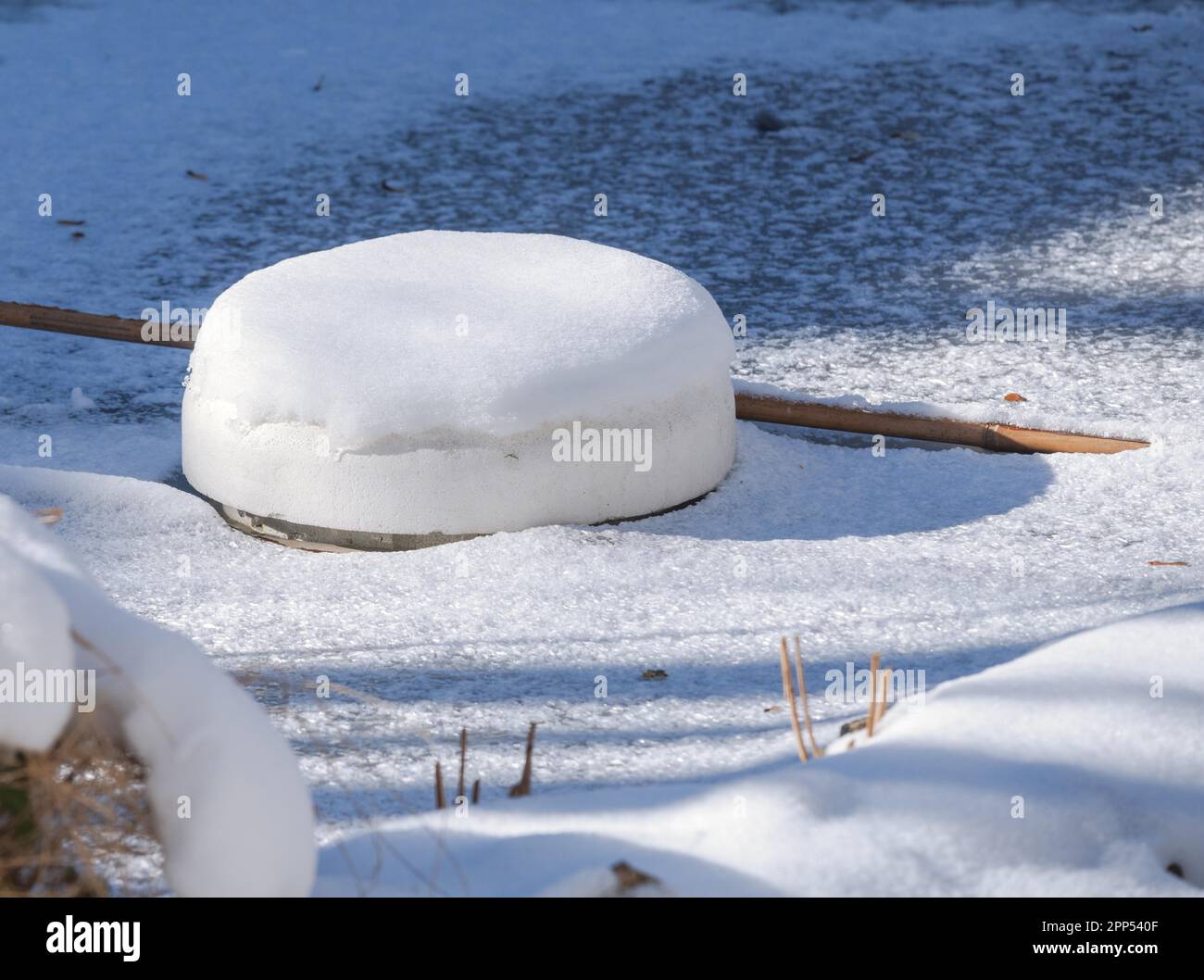 Floating ice preventer made of styrofoam in a frozen pond Stock Photo ...