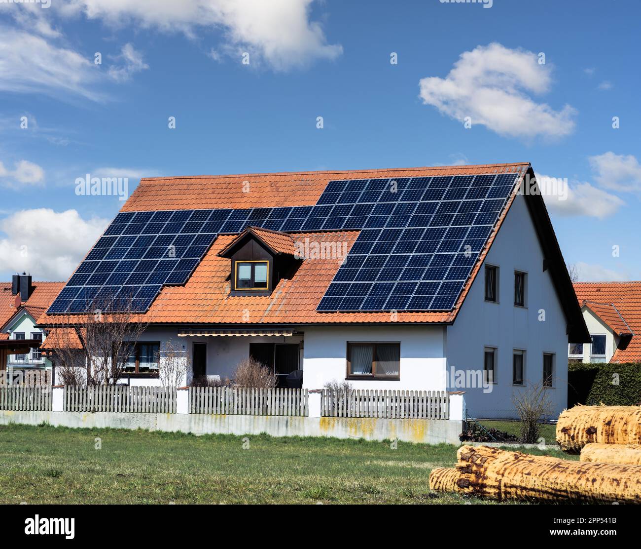 Modern house with photovoltaic solar cells on the roof for alternative ...