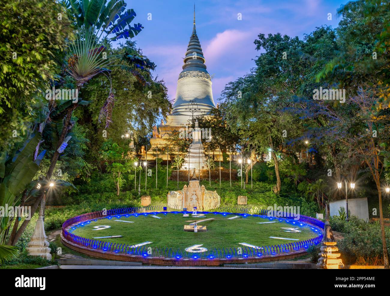In Wat Penh gardens,a gift from China,covered in green grass,a large ...