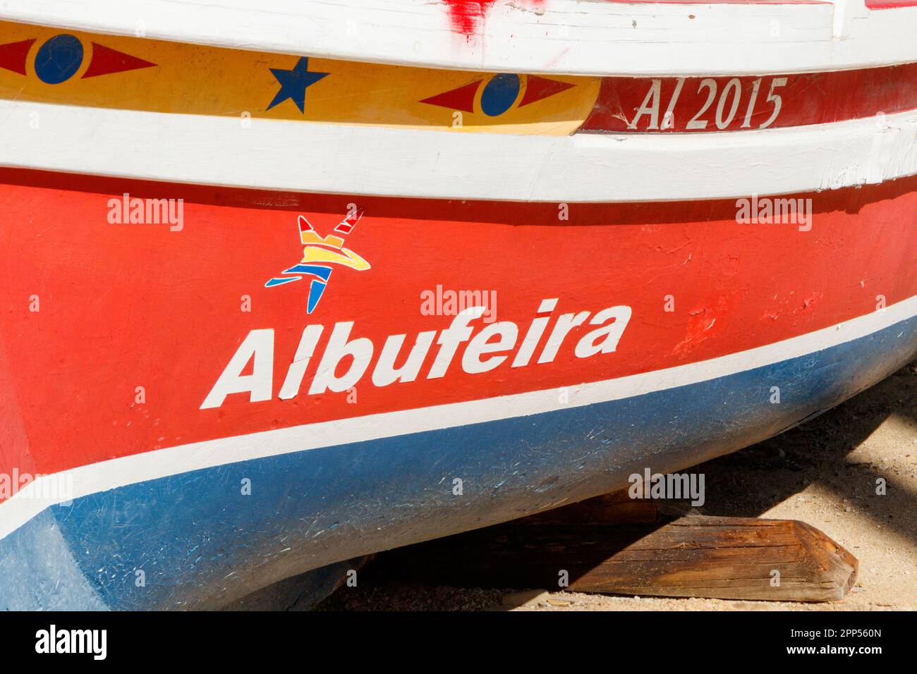painted wooden boat with the name Albufeira written on the side in ...