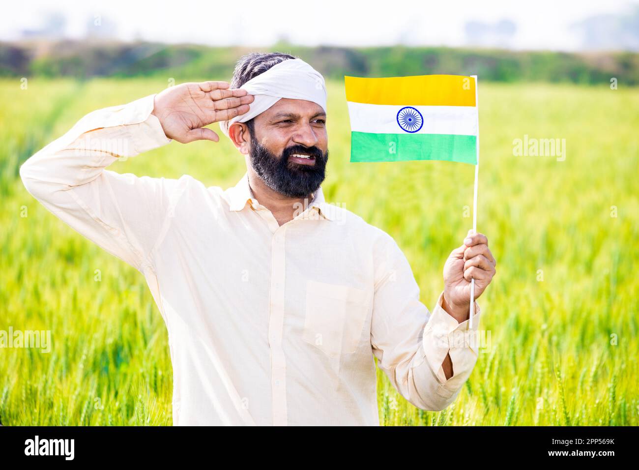 Traditional rural farmer man holding indian and flag salute while ...