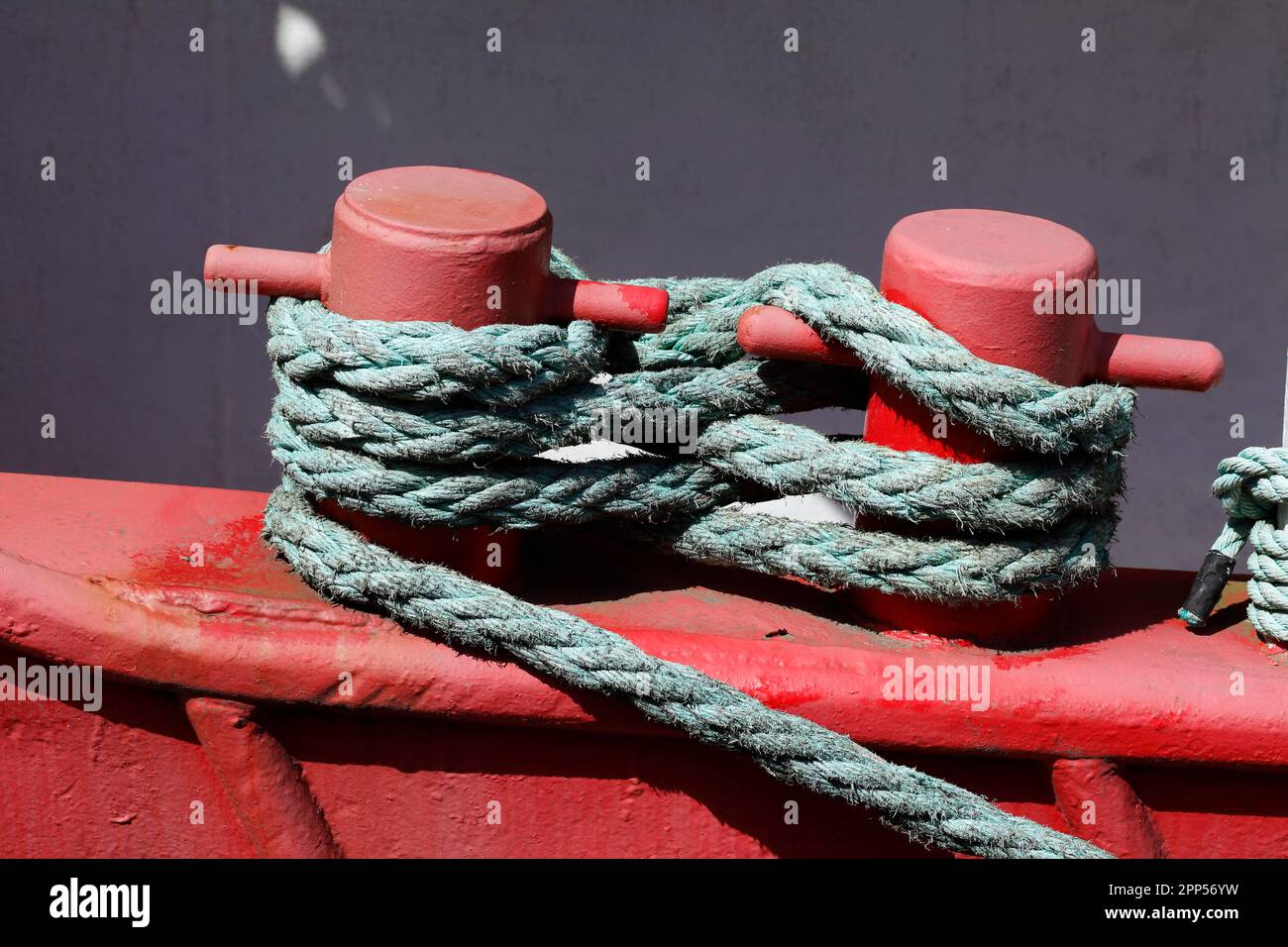 Red ship's bollard wrapped with ship's rope, mooring line, Germany ...