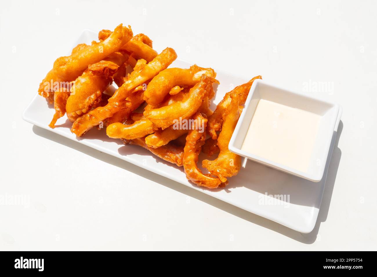 Fried battered squid with mayonnaise sauce. traditional mediterranean ...