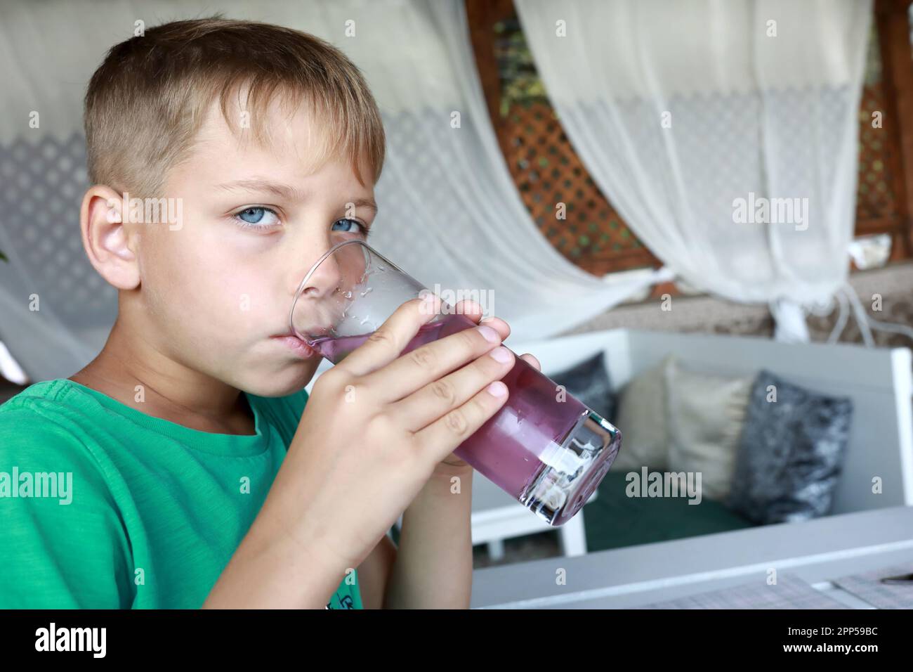 Boy drinking cold lemonade in a restaurant Stock Photo - Alamy