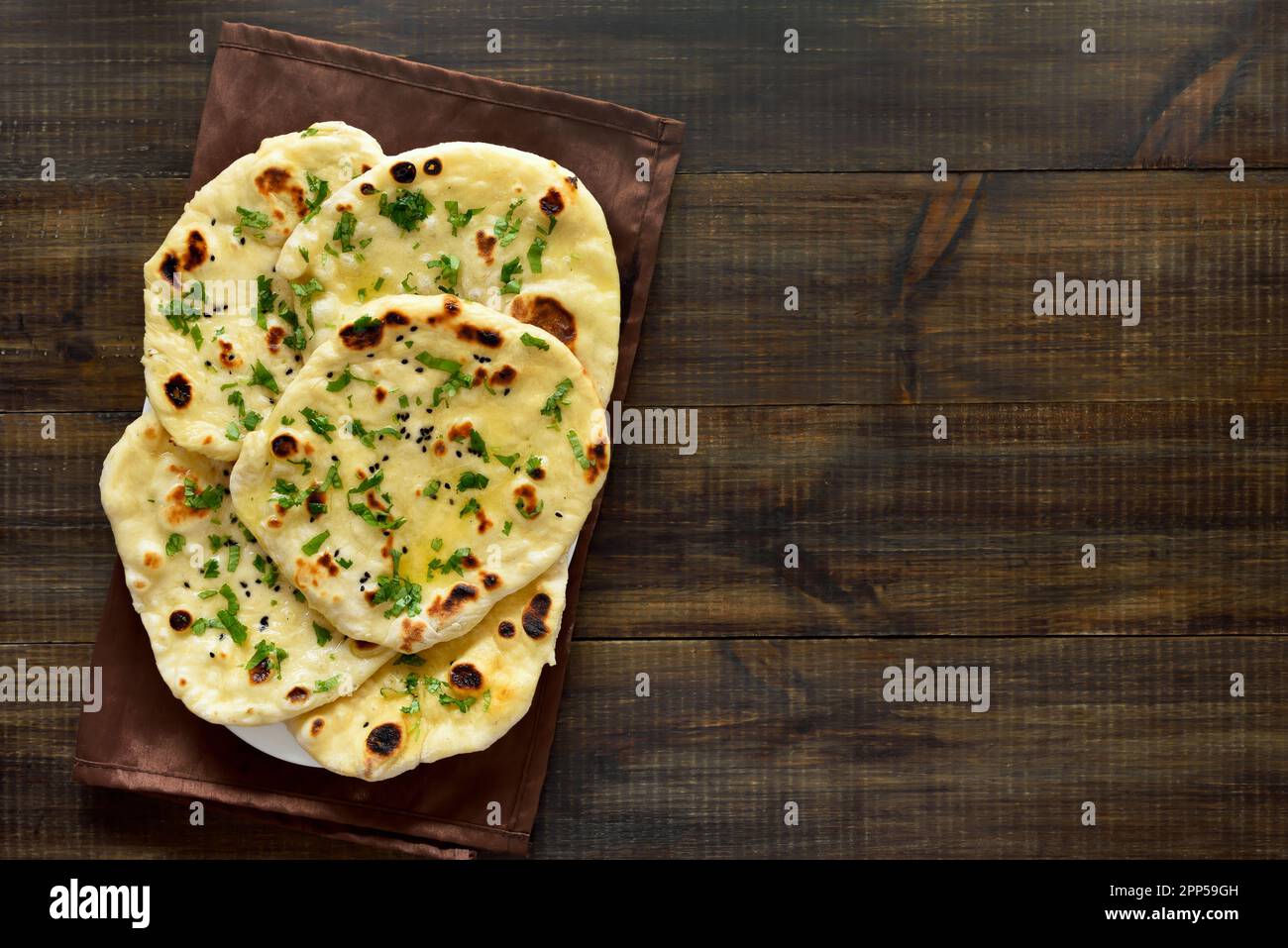 Indian naan bread over wooden background with free text space. Top view ...