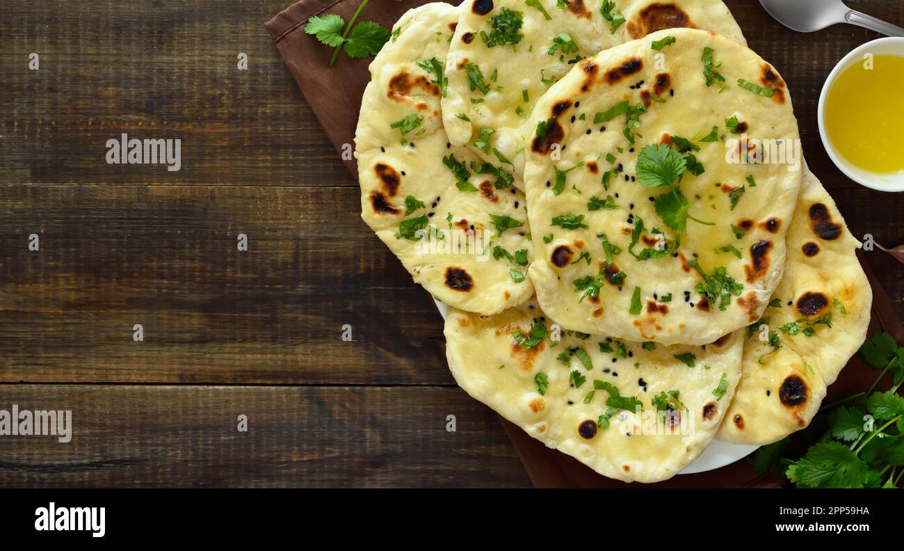 Indian naan bread over wooden background with copy space. Top view ...