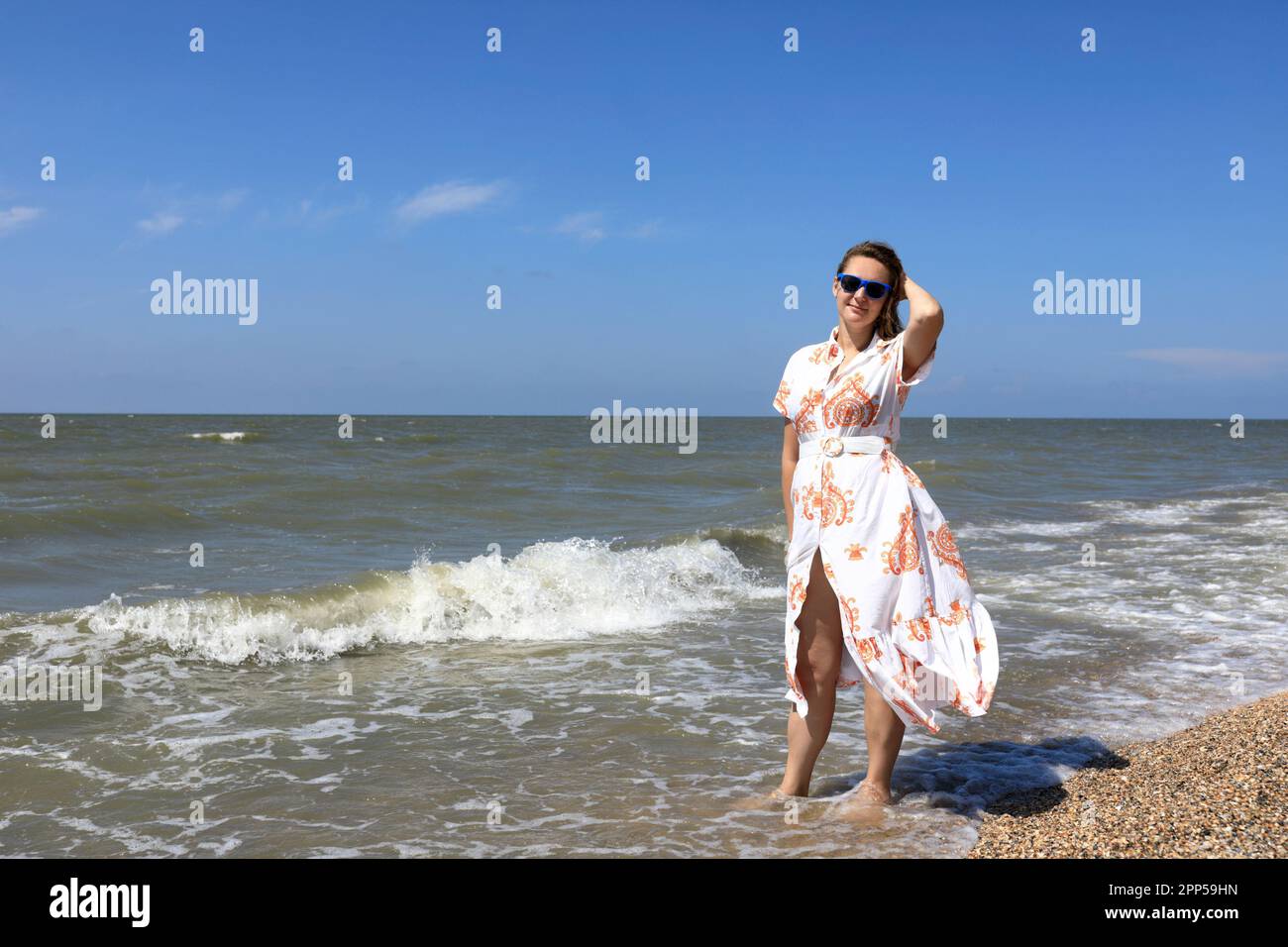 Woman relaxing on pebble beach of Sea of Azov, Primorsko-Akhtarsk Stock ...
