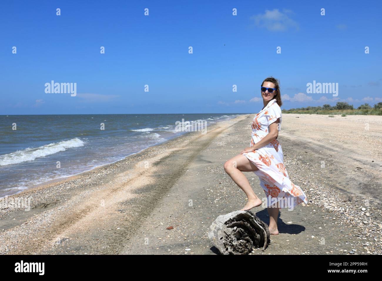 Woman standing on beach of Sea of Azov, Primorsko-Akhtarsk Stock Photo ...