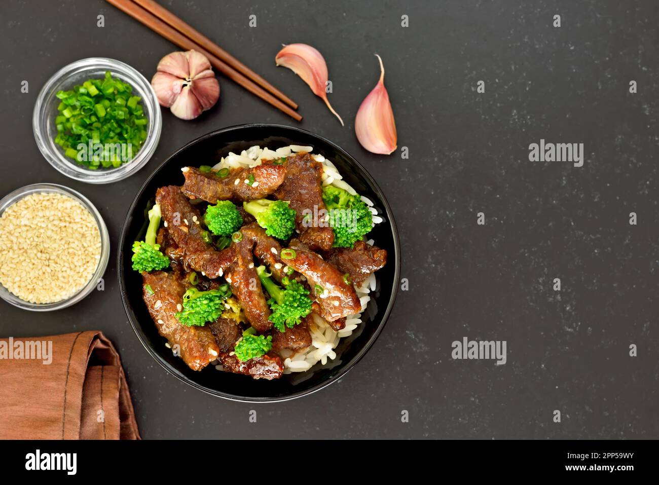 Beef stir-fry with broccoli on black background with copy space. Top ...