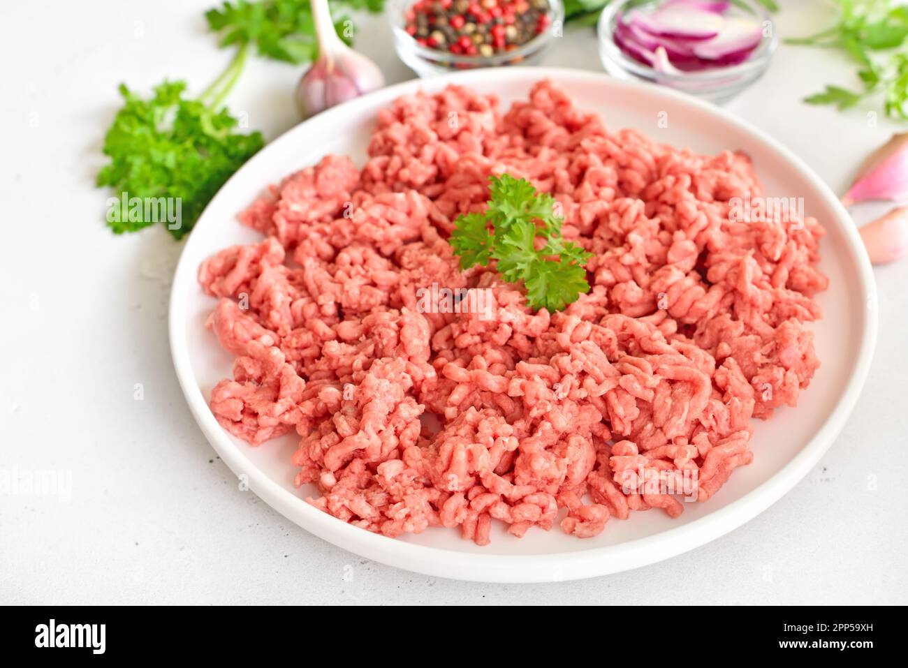 Raw beef minced meat on plate, close up view Stock Photo - Alamy