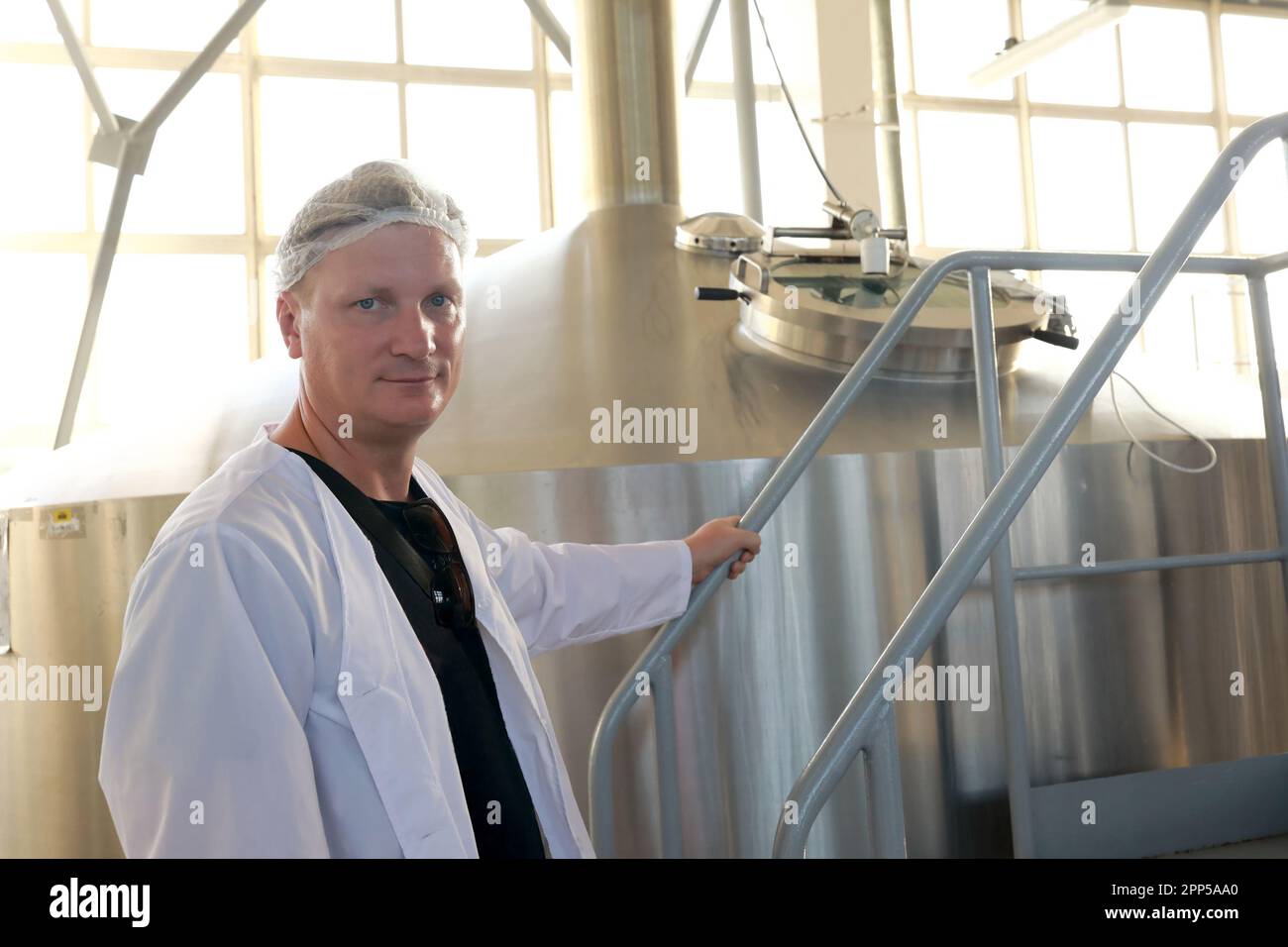 Portrait of serious man in uniform posing at brewery Stock Photo - Alamy