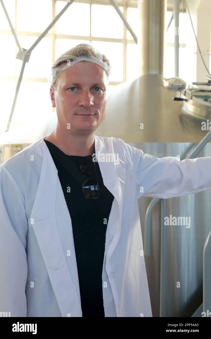 Portrait of tourist in uniform posing at brewery Stock Photo - Alamy