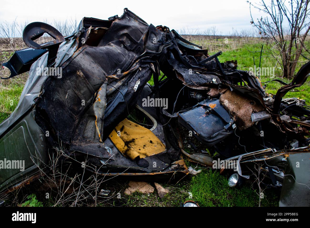 Aftermath of a mine explosion. The car is totally destroyed and debris ...