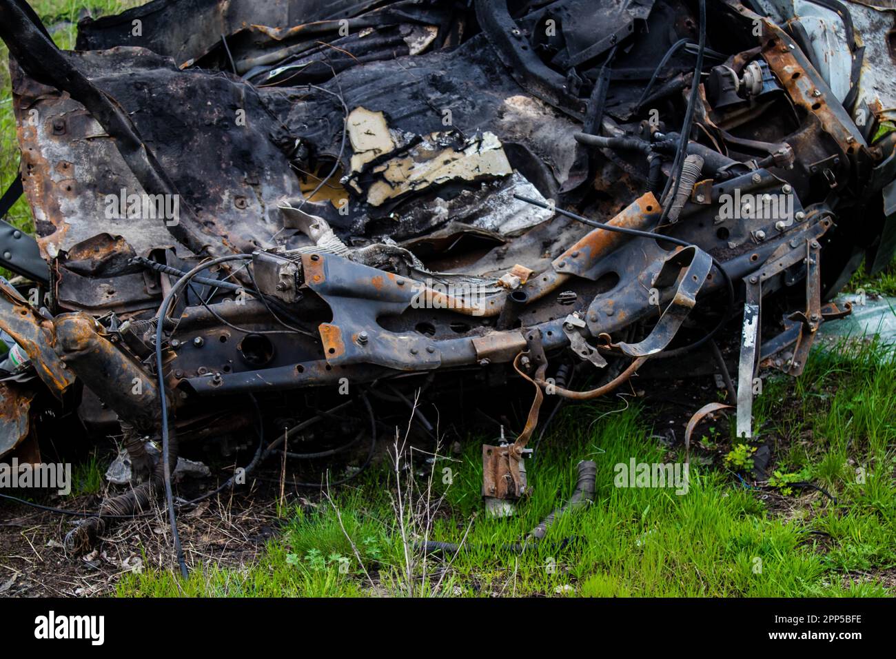 Aftermath of a mine explosion. The car is totally destroyed and debris ...