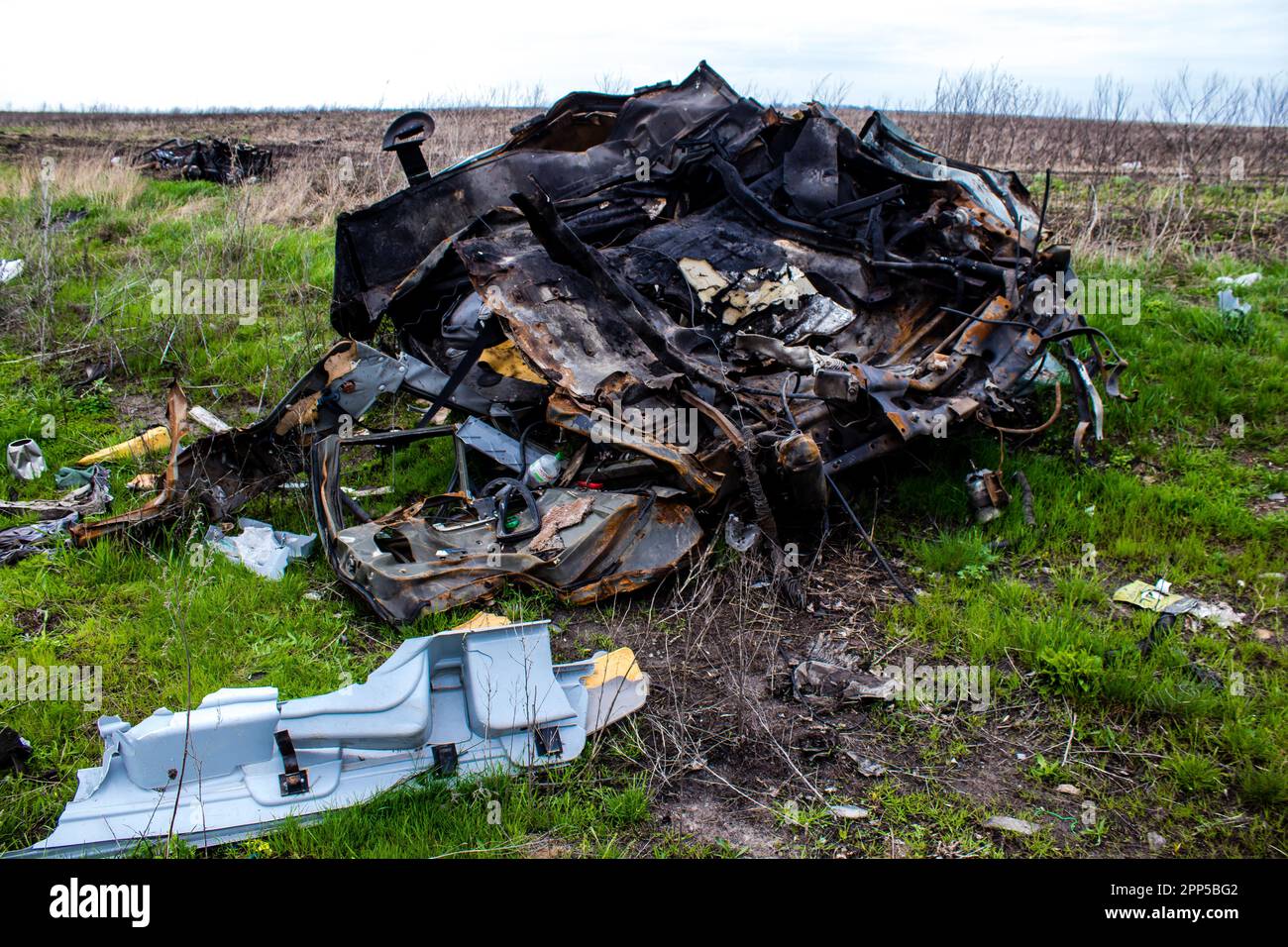 Aftermath of a mine explosion. The car is totally destroyed and debris ...