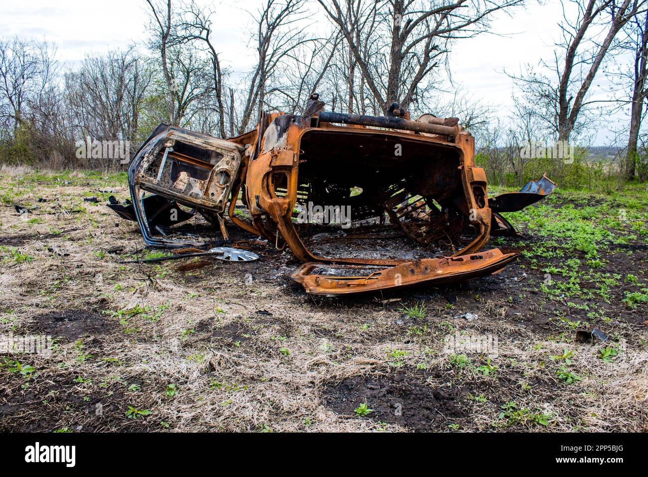 Aftermath of a mine explosion. The car is totally destroyed and debris ...