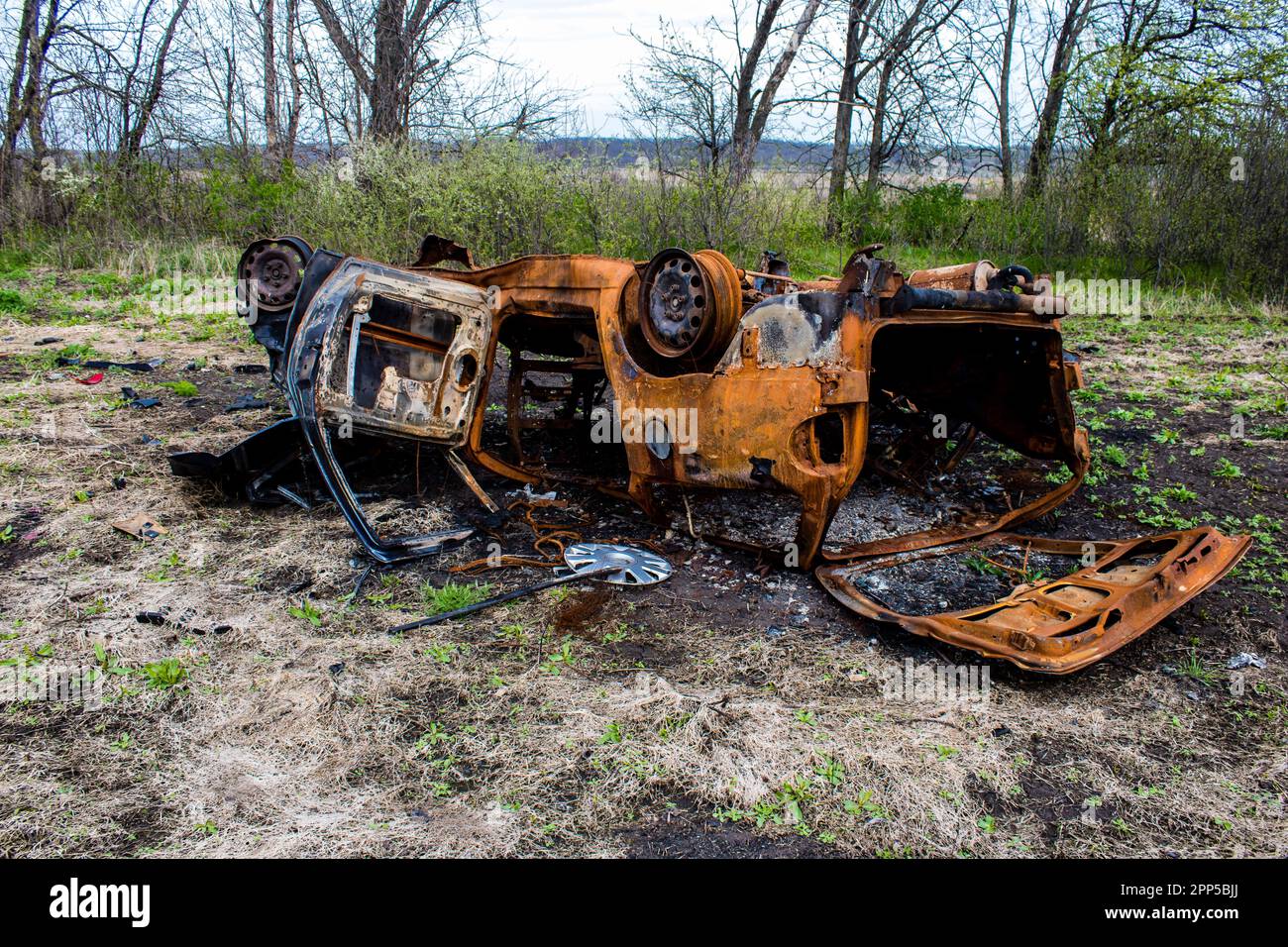 Aftermath of a mine explosion. The car is totally destroyed and debris ...
