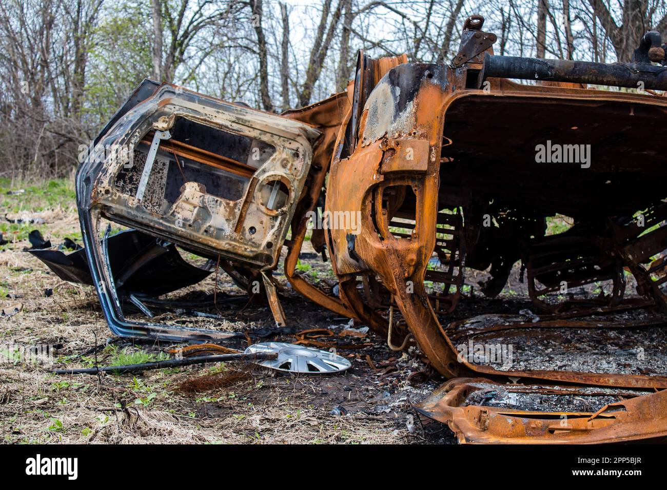 Aftermath of a mine explosion. The car is totally destroyed and debris ...