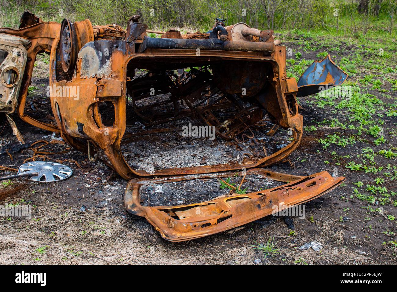 Aftermath of a mine explosion. The car is totally destroyed and debris ...