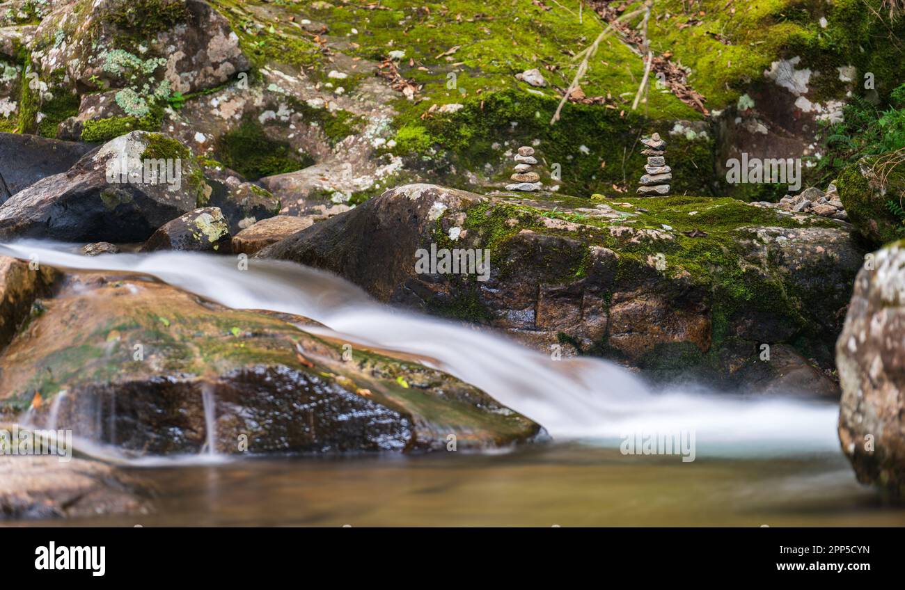 Peaceful Stone Marked Path Along Serene River Stock Photo - Alamy