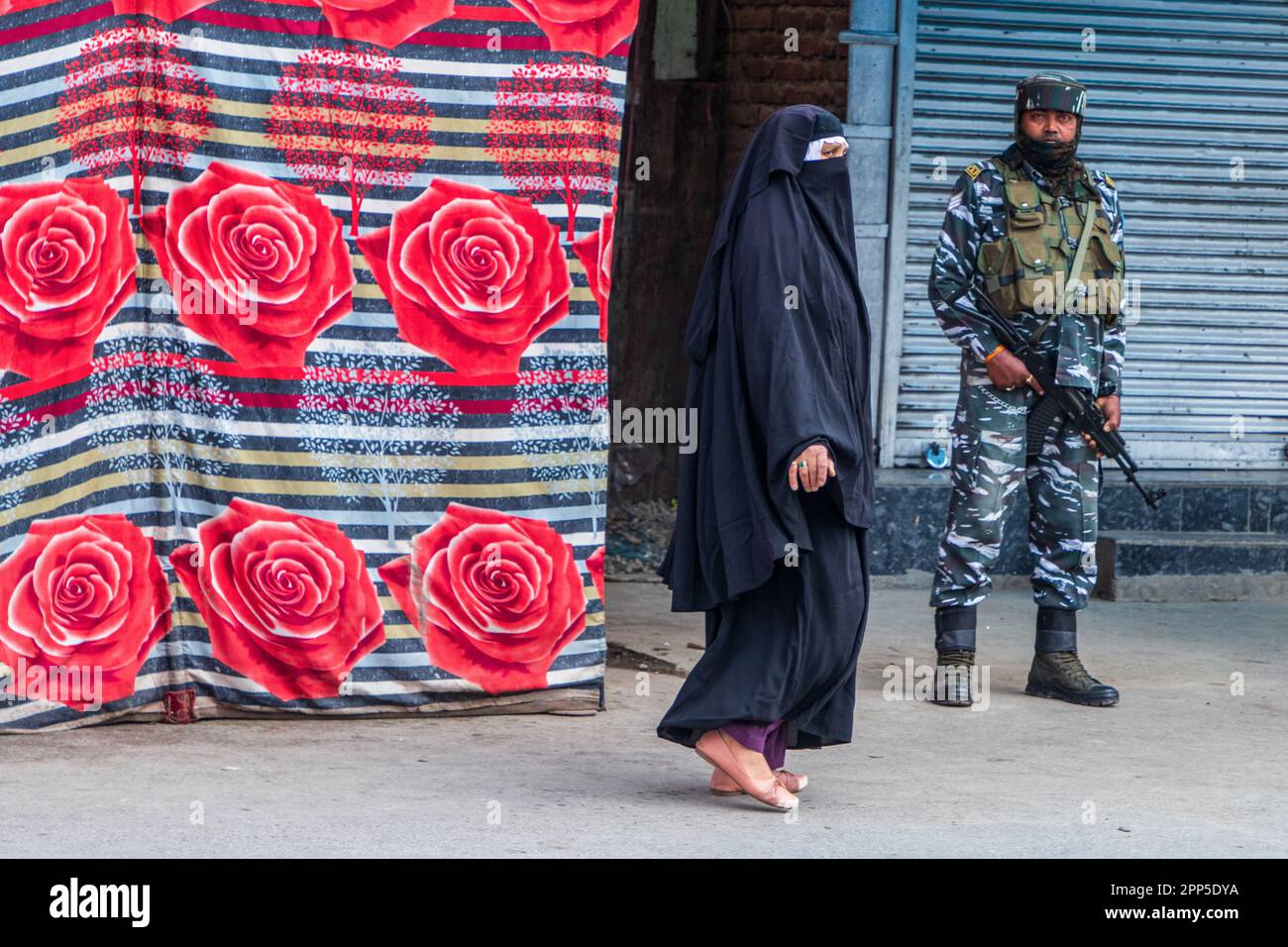 Srinagar, India. 22nd Apr, 2023. A Kashmiri Burqa-clad woman walks past ...