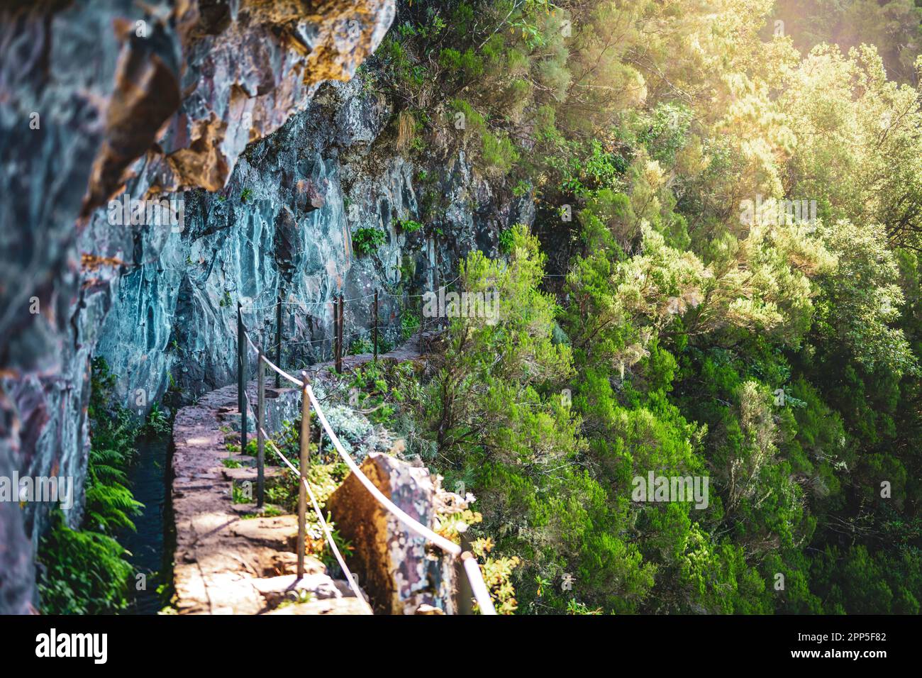 Description: Steep cliff hiking trail next to water canal through ...