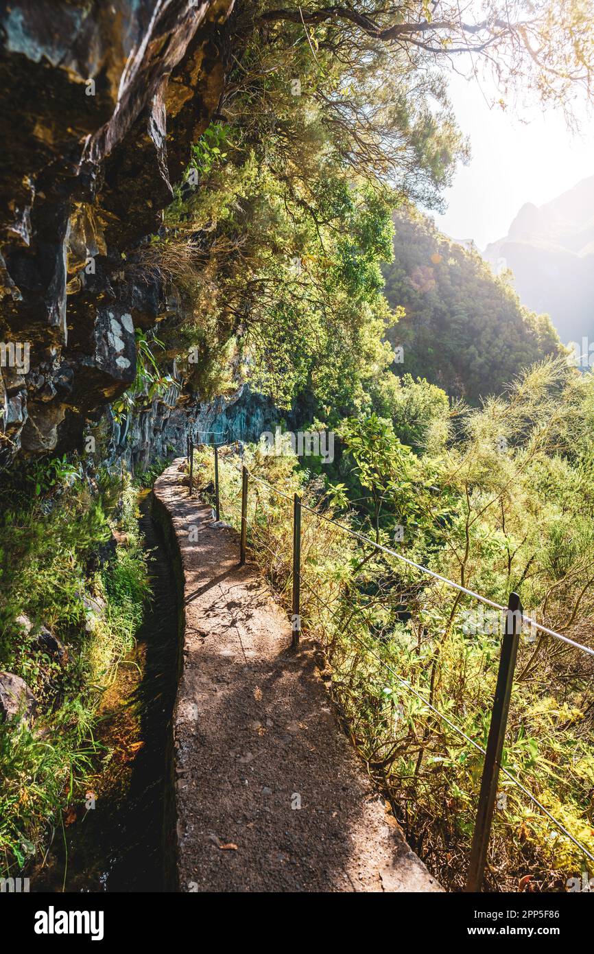 Description: Steep cliff hiking trail next to clear water canal through ...