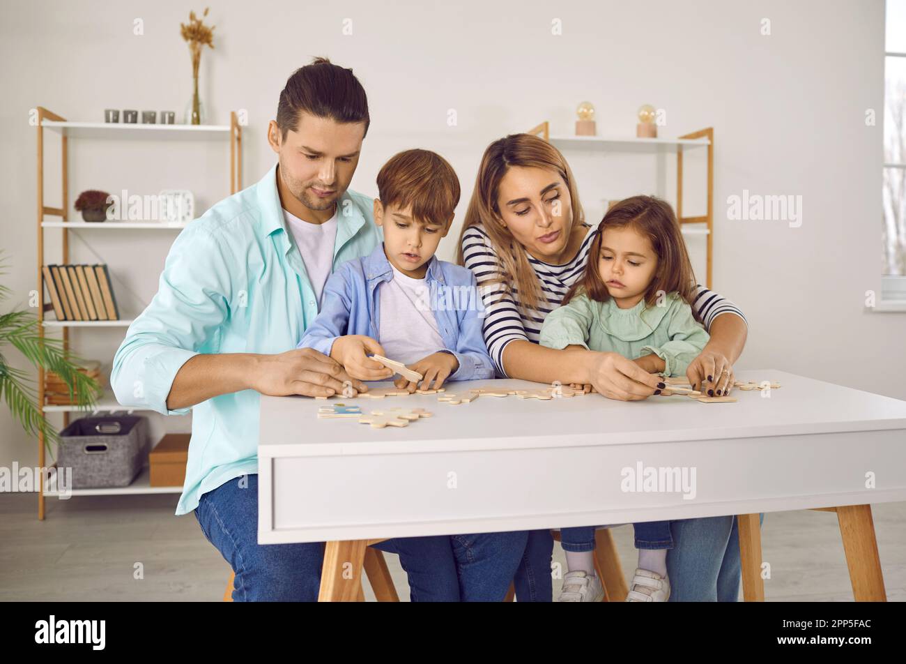 Children doing puzzle at table hi-res stock photography and images - Alamy