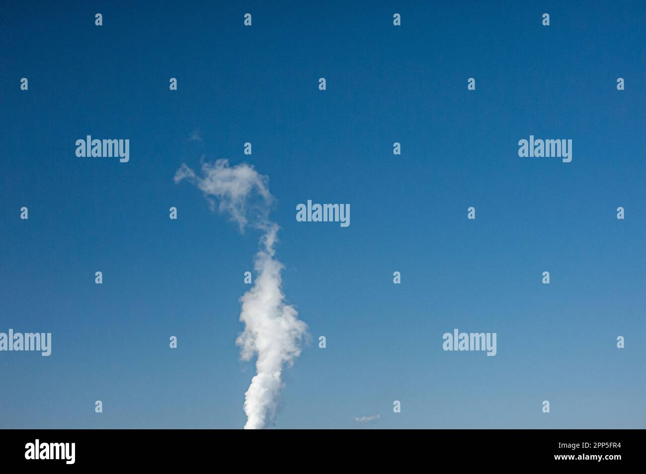 Steam rising from a power plant on a sunny day Stock Photo - Alamy