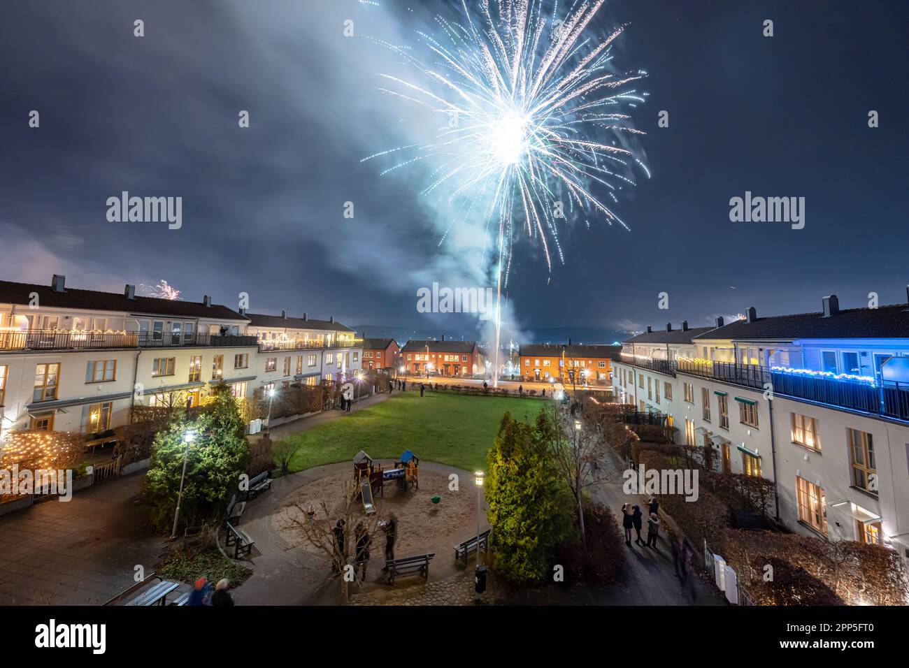 Fireworks launched between rows of houses Stock Photo - Alamy
