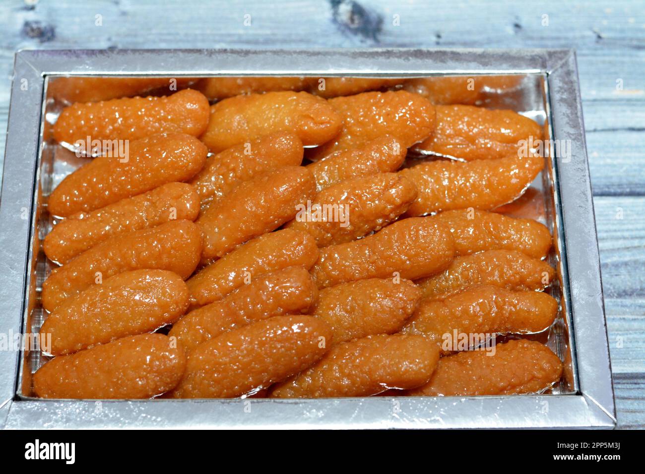 Egyptian Zainab fingers or glazed anise fingers, flour with semolina in ...