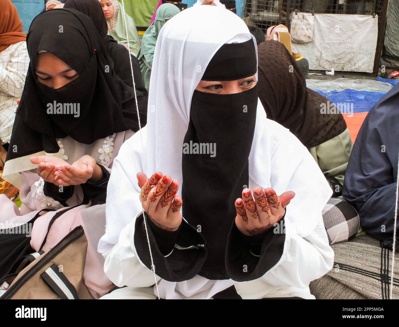 Manila, Philippines. 22nd Apr, 2023. A Muslim woman with an open palm ...