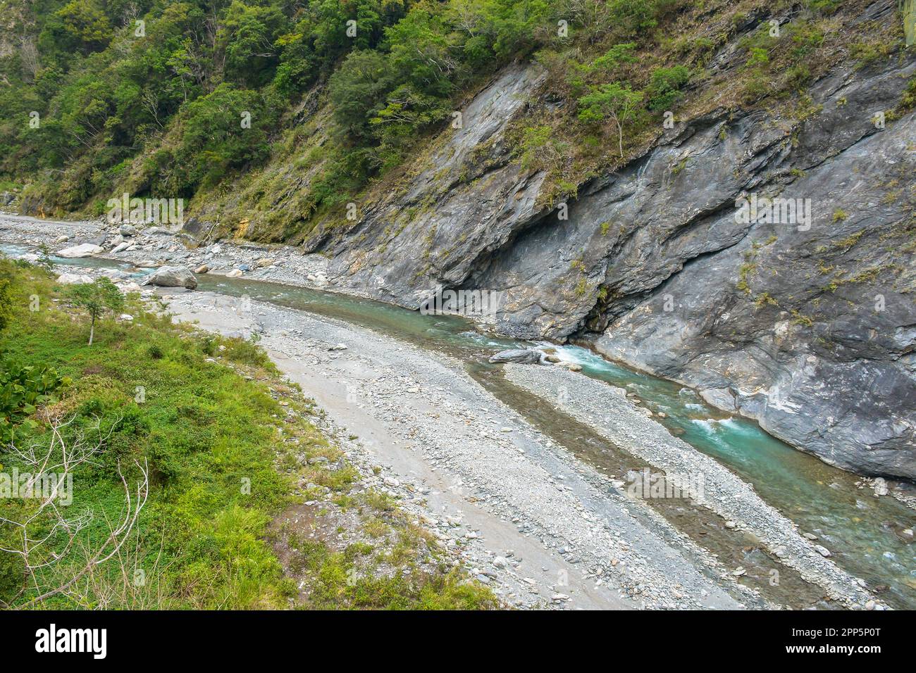 Green mountain gorge with small creek flows through the middle in ...