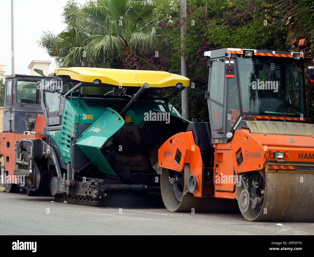 Cairo, Egypt, April 8 2023: Asphalt paver trucks and compactors, A ...