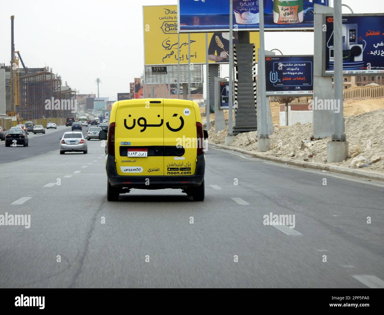 Giza, Egypt, April 9 2023: Noon online shopping delivery yellow van to ...