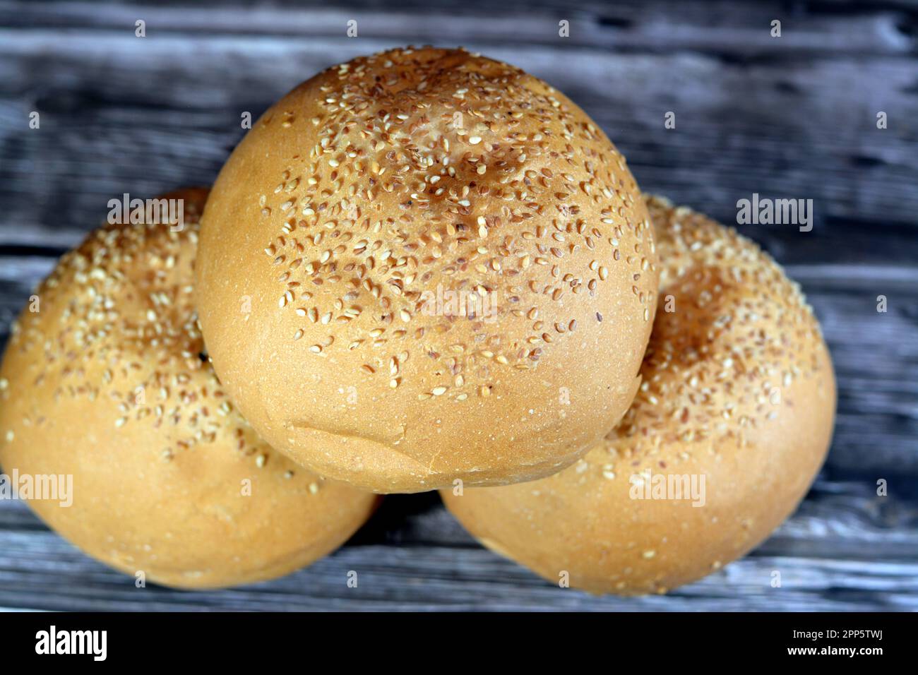 Round hand sized hamburger burger bun baked and covered with sesame ...