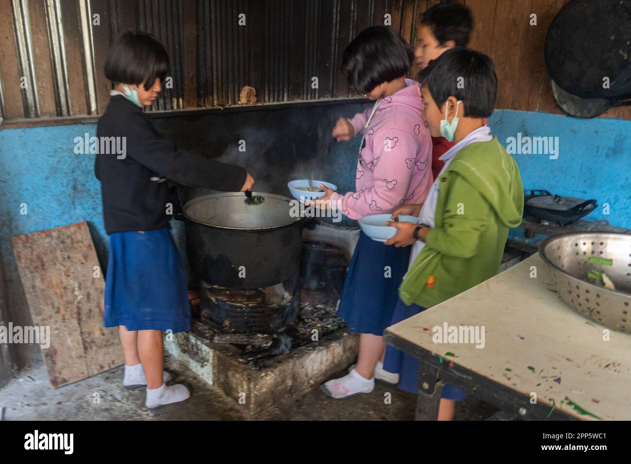 Children cooking their lunch over fire in a rural school Stock Photo ...